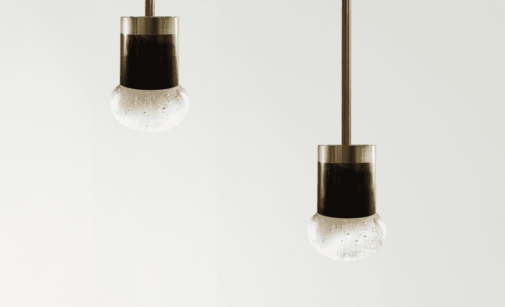 The Kinet pendant light – brass and blown glass diffusers.